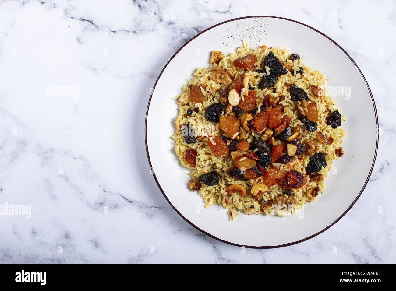 Rice dish, with the addition of dried fruits, nuts and spices of Middle ...