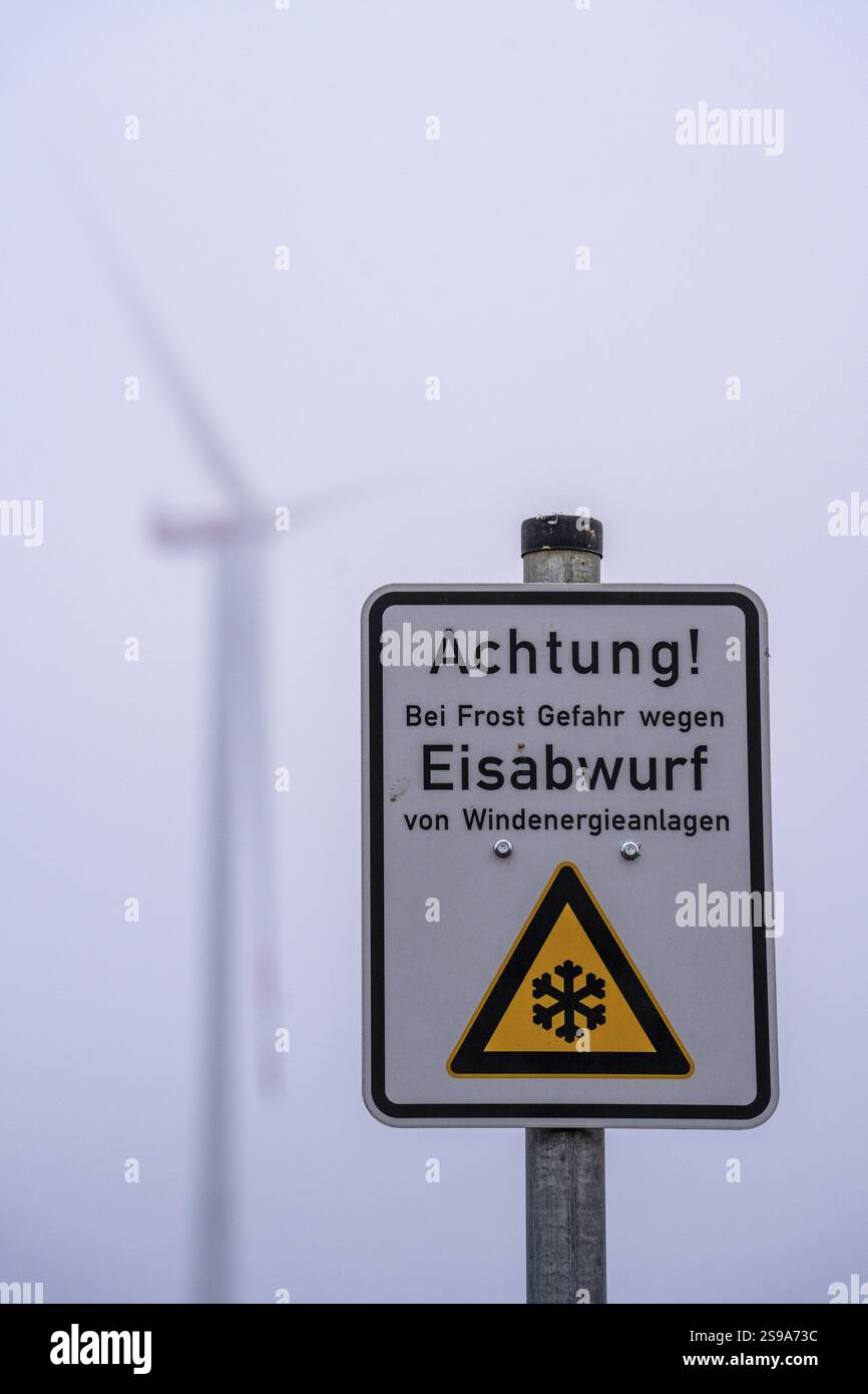 Sign warns of ice shedding from wind turbines, in frost, ice deposits ...