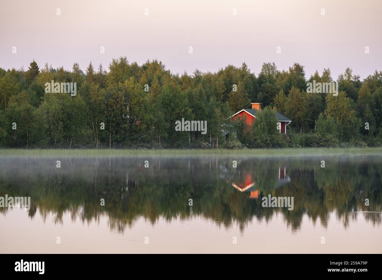 Red hut reflected in lake, Muonio, Lapland, Finland, Europe Stock Photo ...