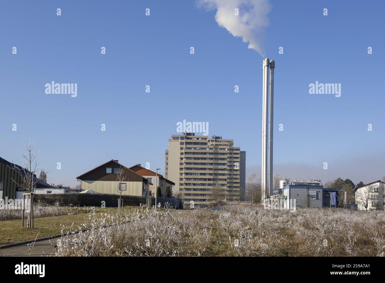 High chimney with smoke emission, residential building and frosty ...