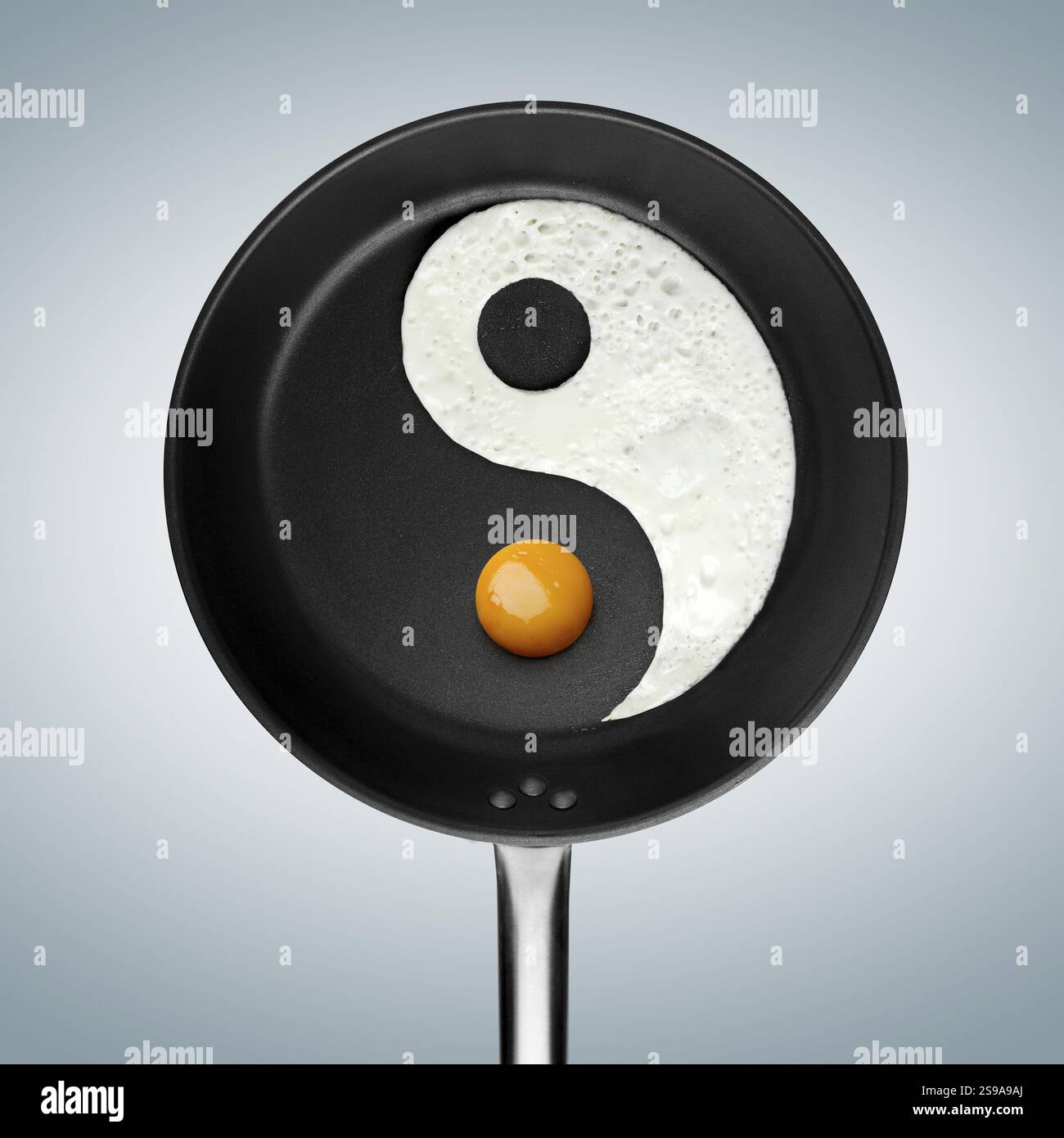 A Yin Yan symbol made from a fried egg in a pan Stock Photo - Alamy