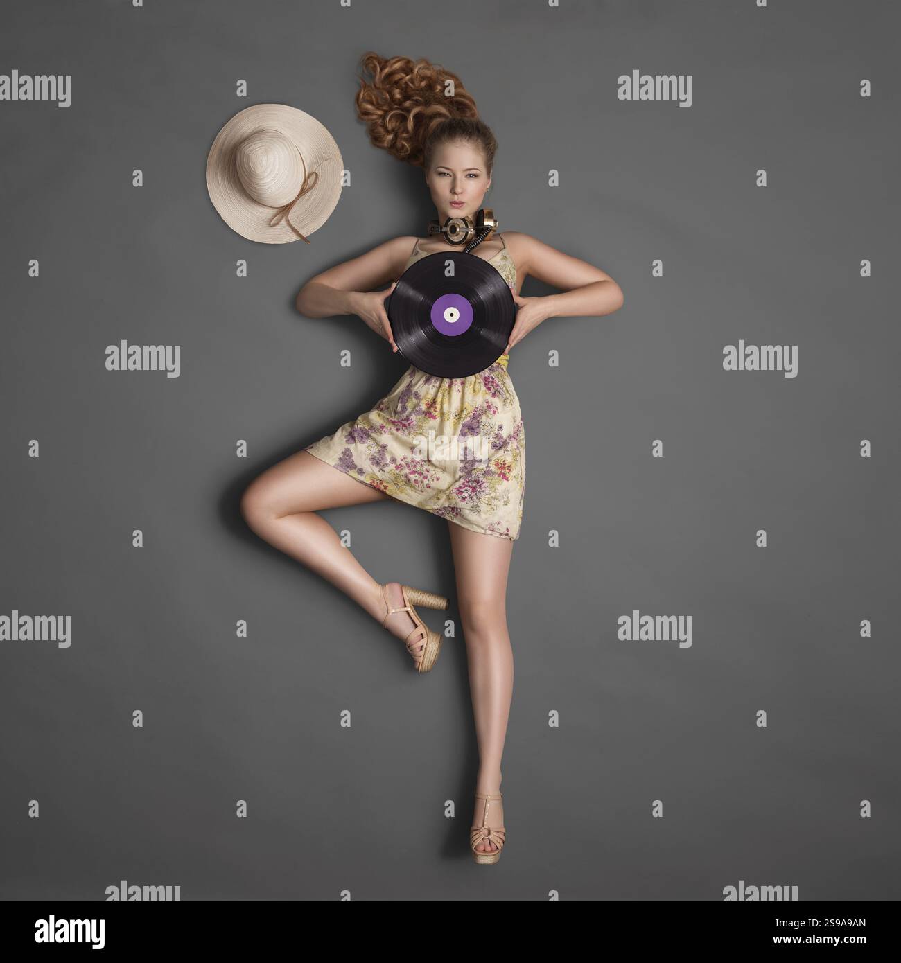 Beautiful girl, wearing vintage music headphones around her neck and ...