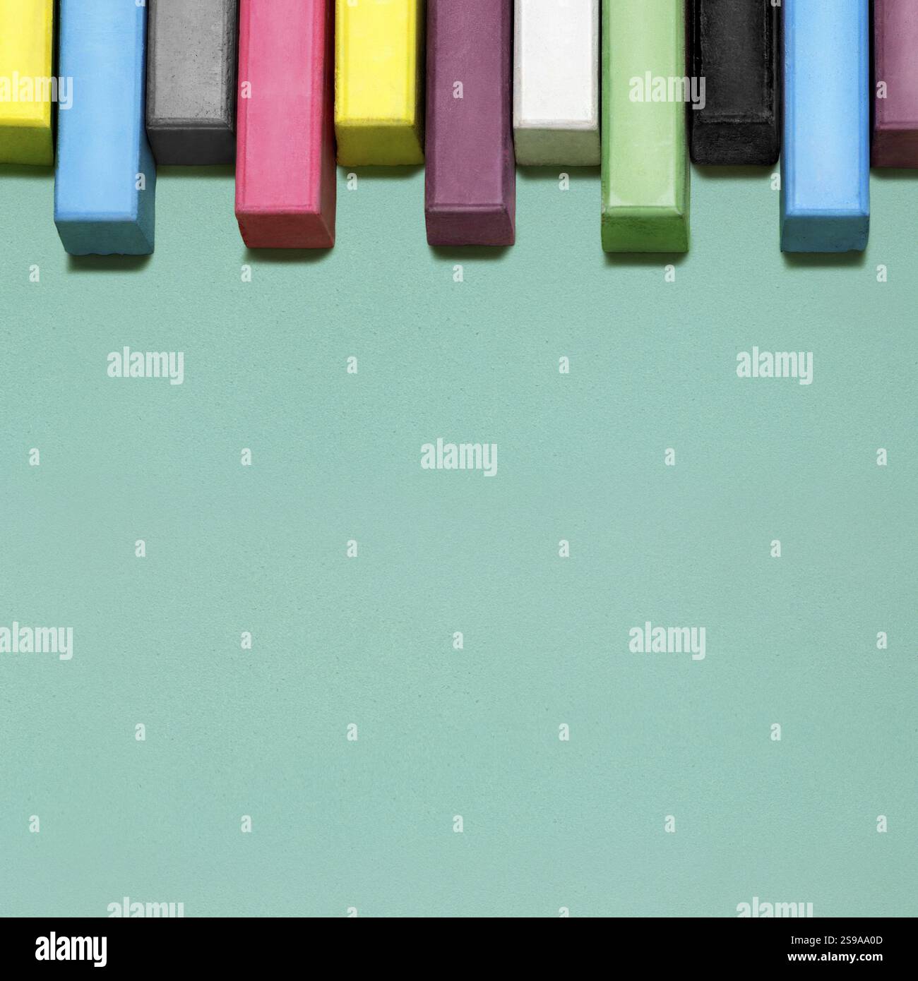 Creative still life of colourful chalks lined up like piano keys Stock ...