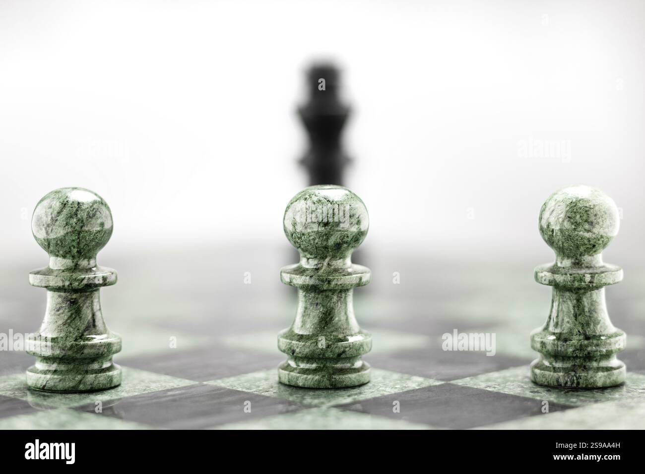 Three pawns in their raw state in front of a king shape Stock Photo - Alamy