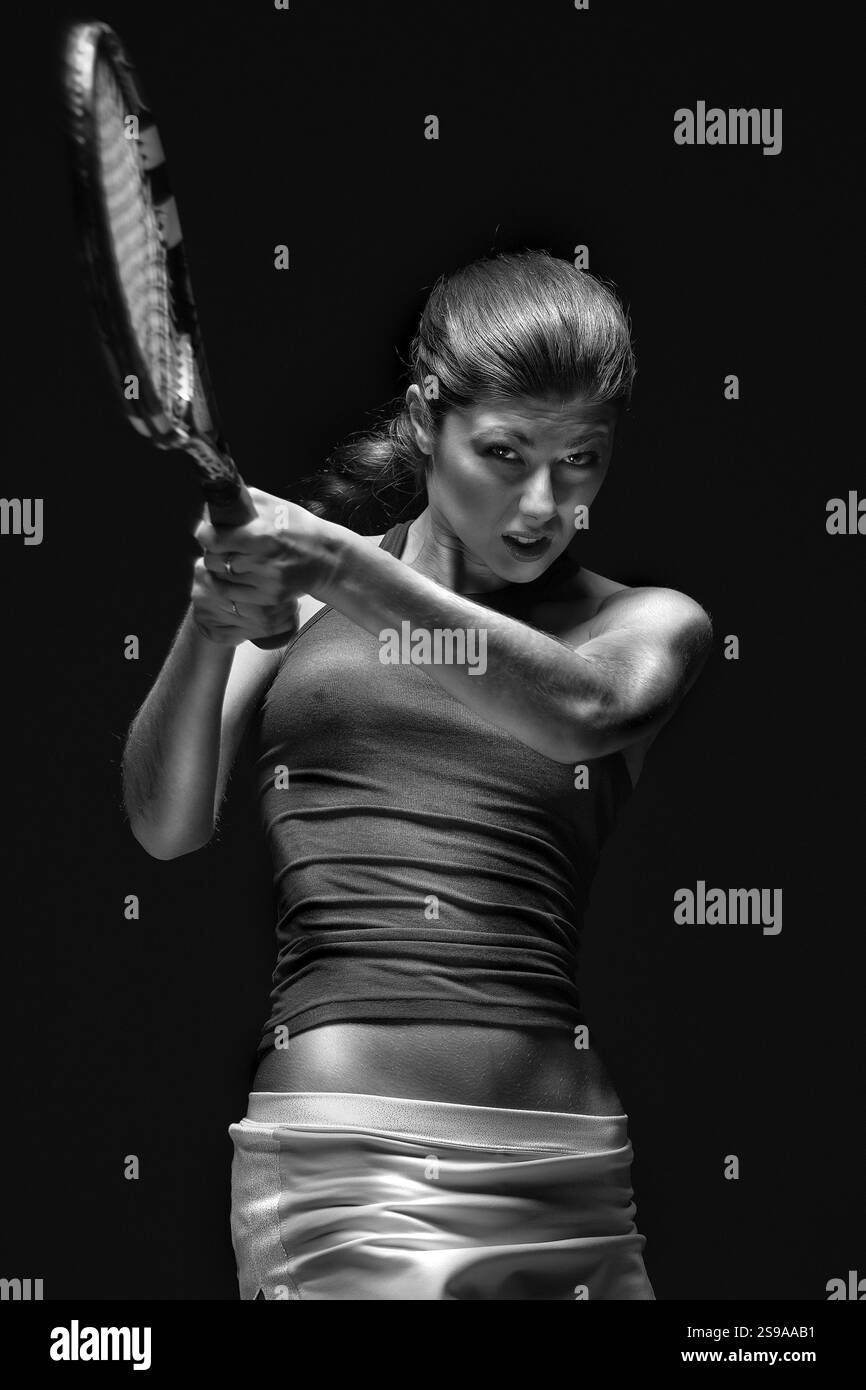 Tennis player holding racket behind her head, in front of black ...