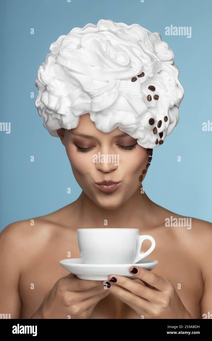 A young lady with whipped cream on her head and a coffee cup Stock ...