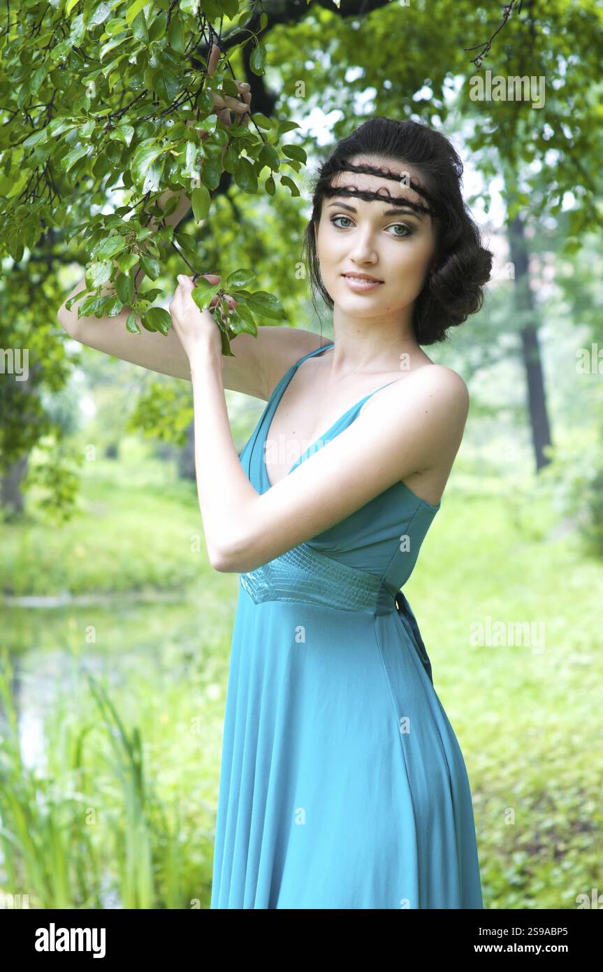 Portrait of a beautiful woman in a green garden, ST. Petersburg, Russia ...