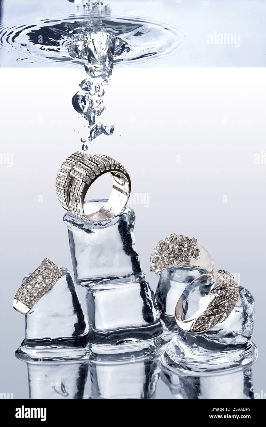 A look at jewellery falling onto ice cubes under water Stock Photo - Alamy