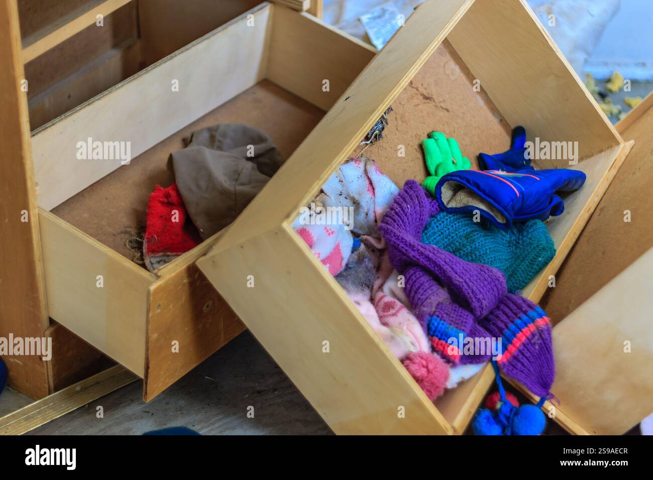 A messy drawer with a pile of clothes and a pair of gloves. The drawer ...