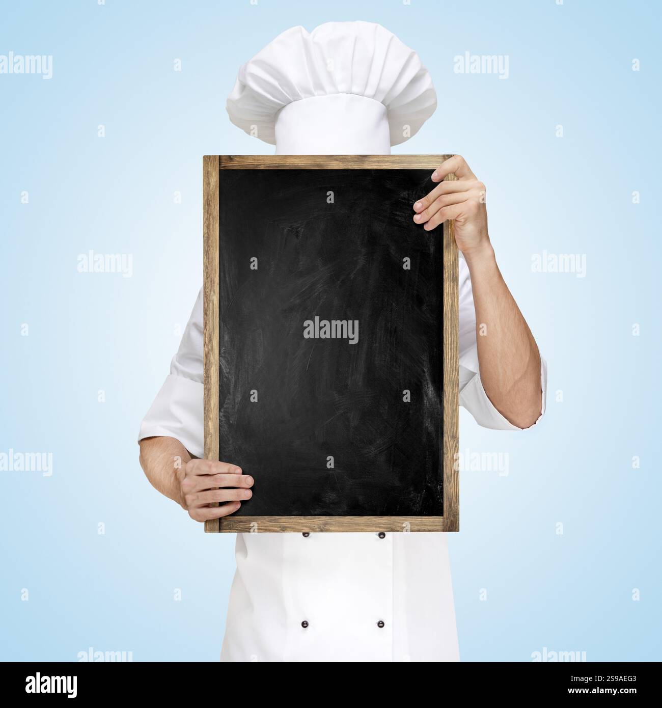 Restaurant chef hides behind a blank chalkboard for a business lunch ...