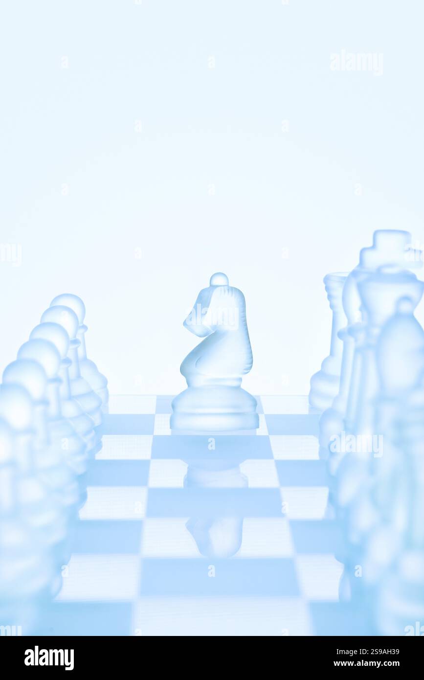 Chess game concept of an icy frosted chess knight standing between ...