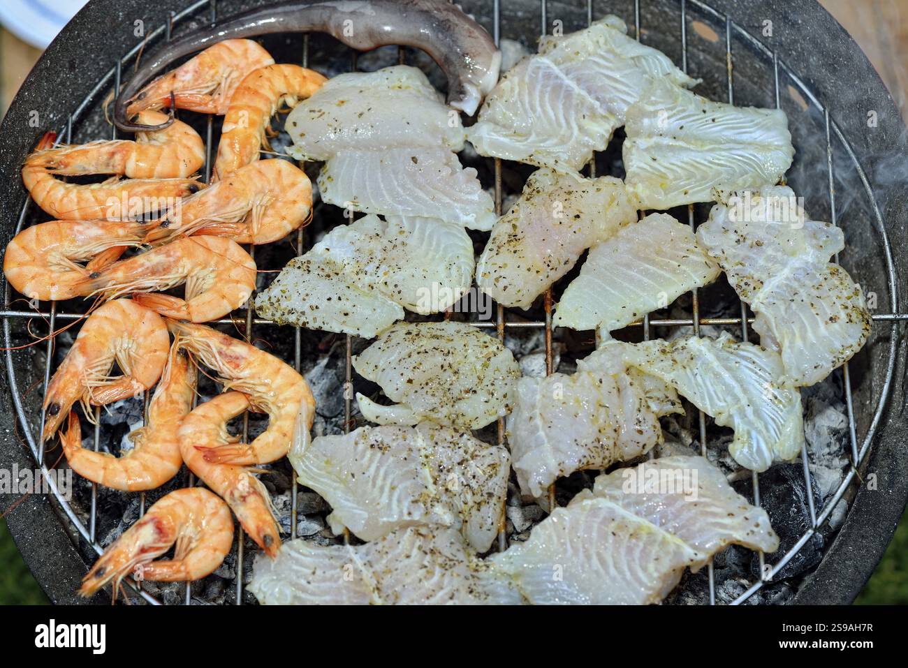 Grilled fish and prawns on the barbecue Stock Photo - Alamy