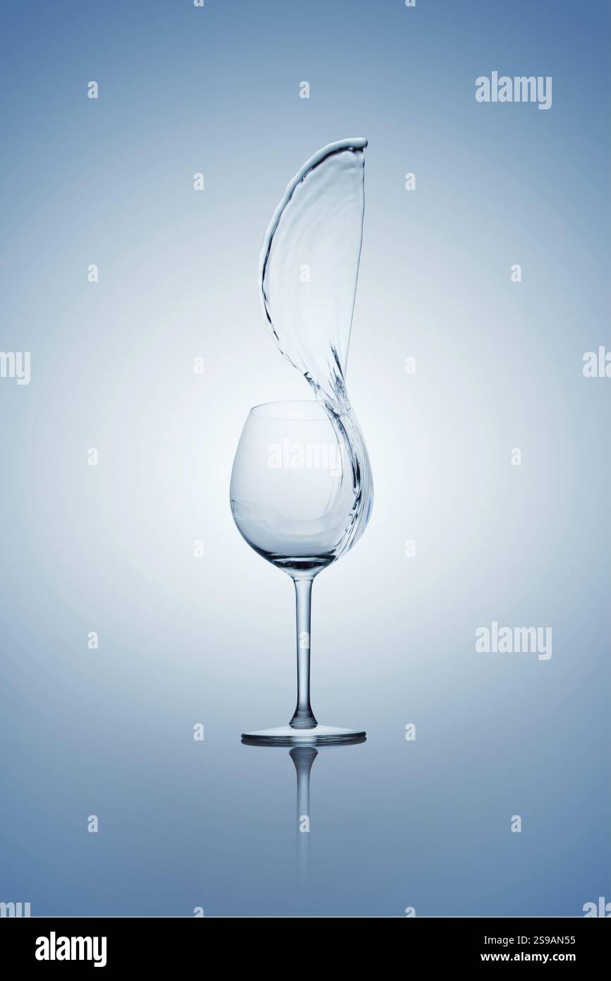 Water splashing into or leaking from a wine glass with a stem Stock ...