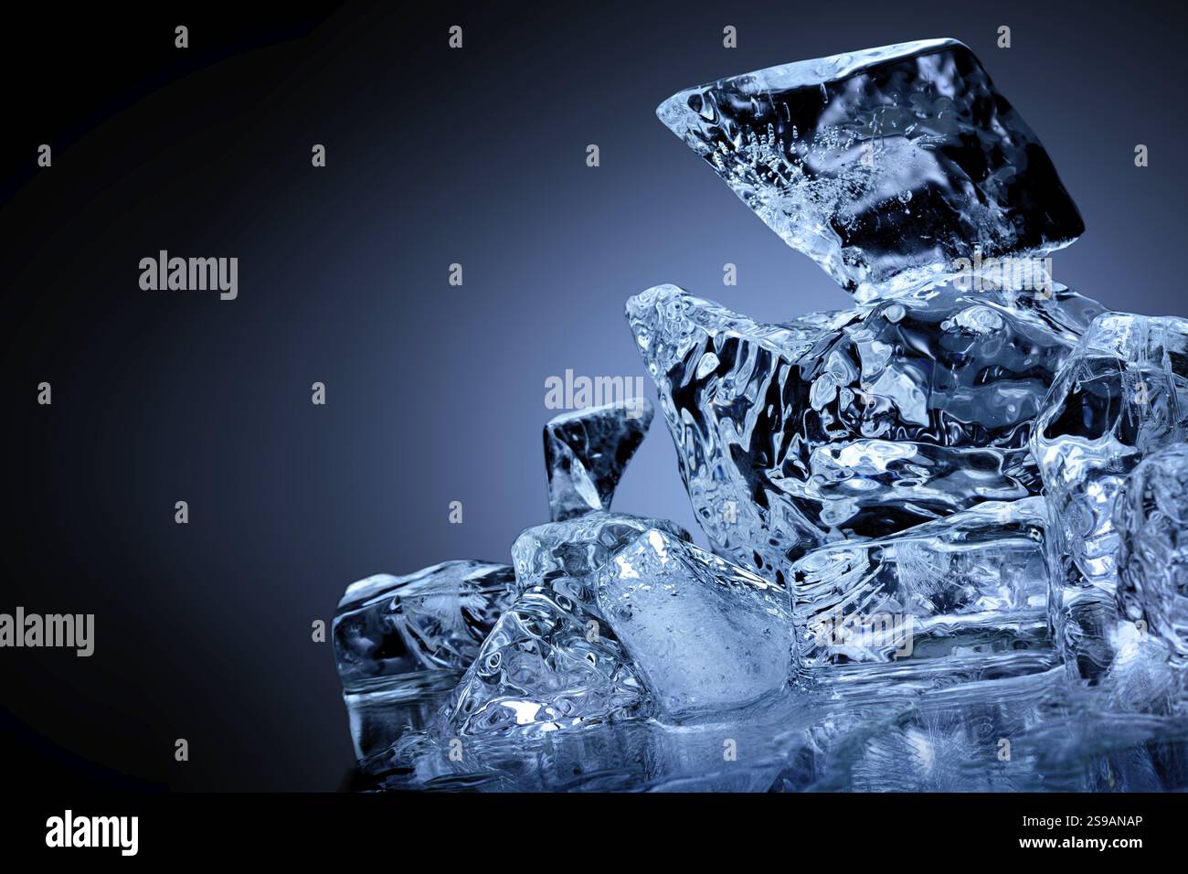 Frozen block of ice with blue tinted background Stock Photo - Alamy