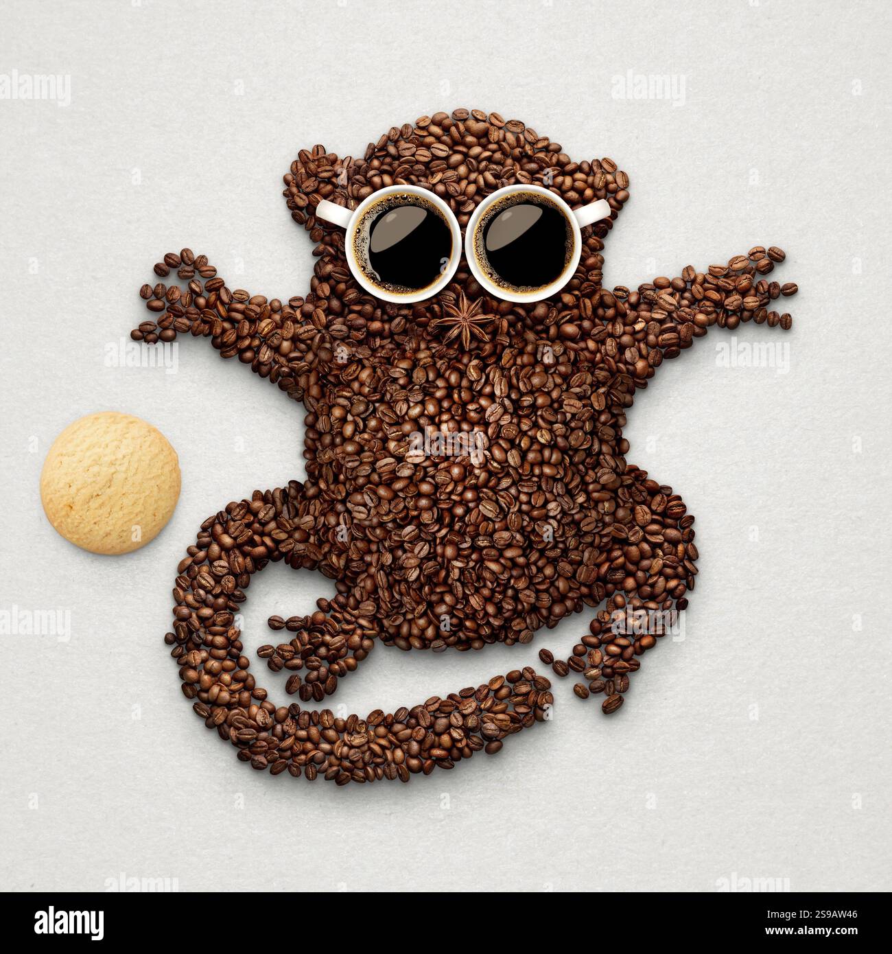 A fun tarsier of roasted coffee beans, two cups and star anise with an ...