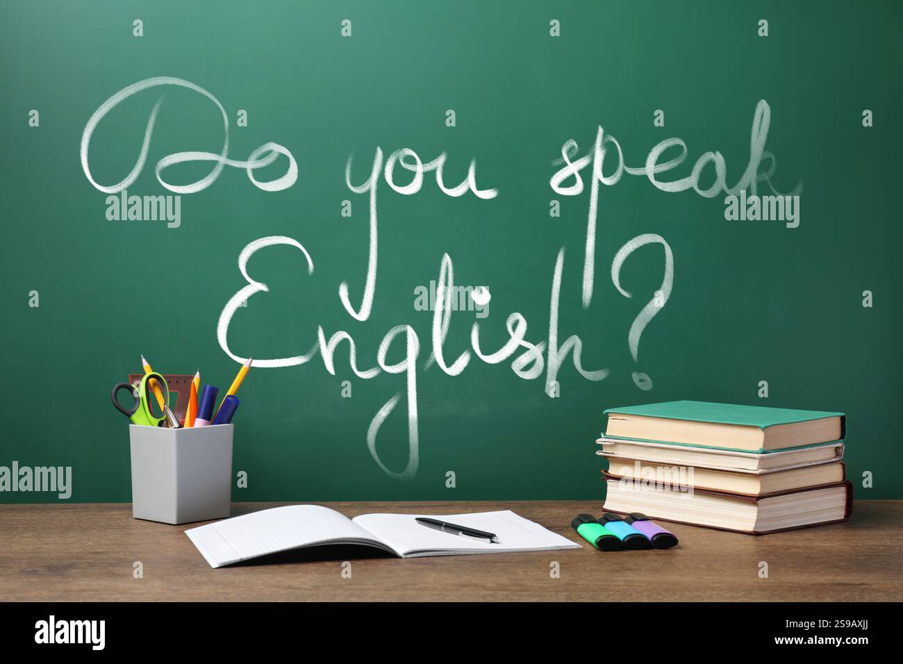 Do You Speak English? text on green chalkboard and stationery on desk ...