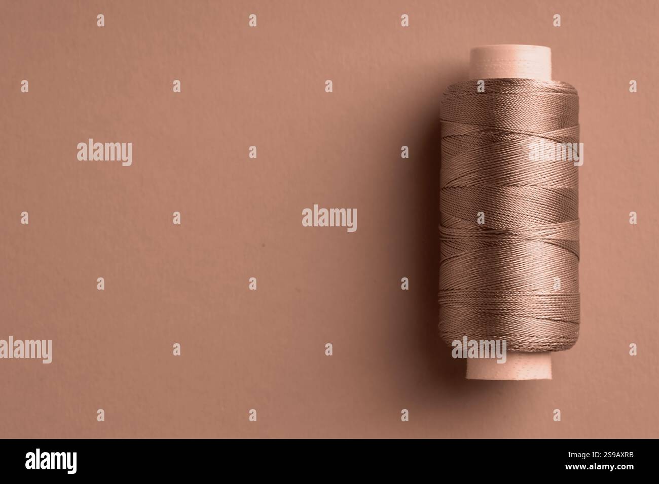 Sewing thread in mocha mousse shade, top view. Trendy color of 2025 ...