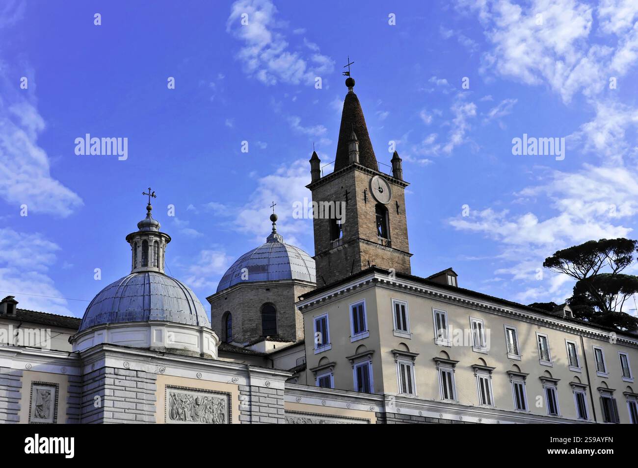 Historic building with a church tower and domes under a clear blue sky ...