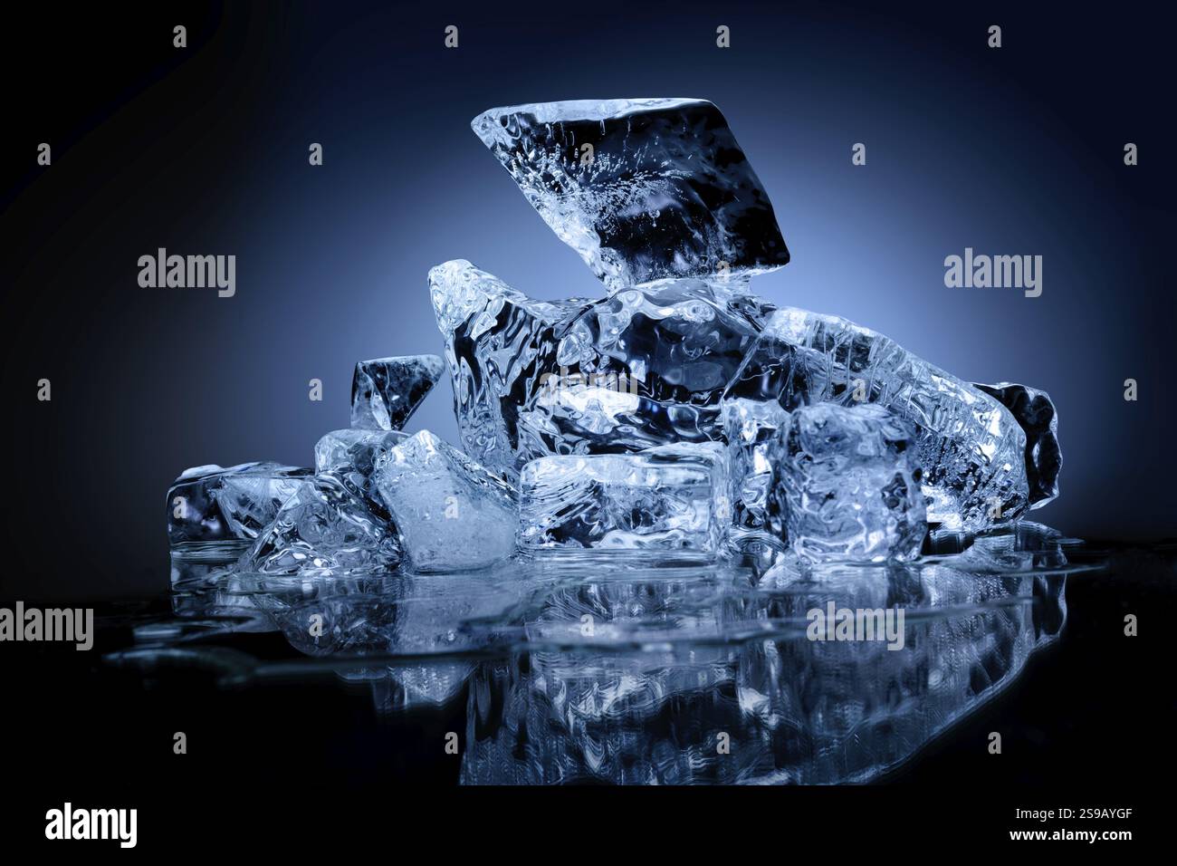 Frozen block of ice with blue tinted background Stock Photo - Alamy
