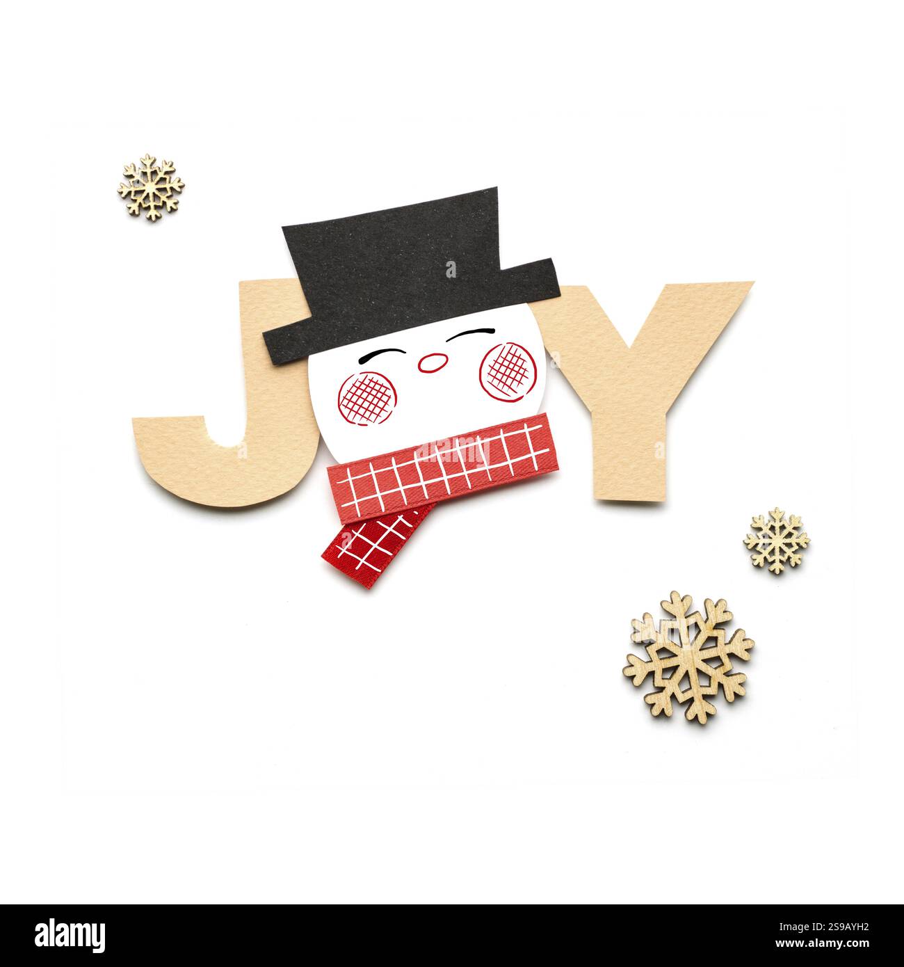 Creative photo of a paper snowman with joy sign on a white background ...