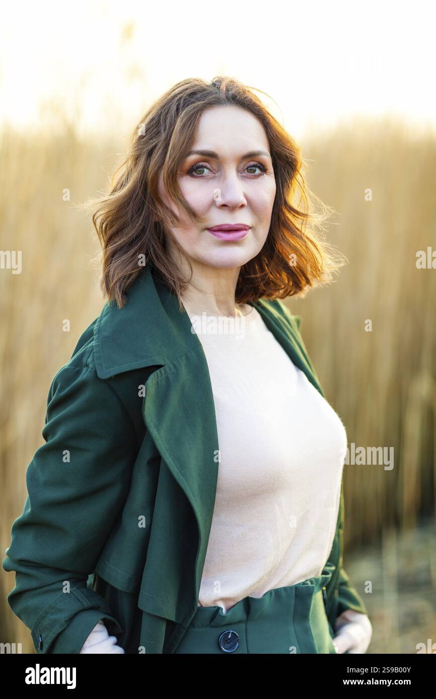 Portrait of a beautiful middle-aged woman posing at sunset Stock Photo ...