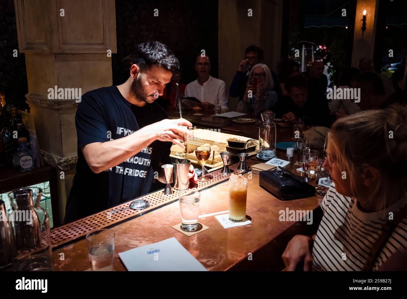 Greek bartender mixing cocktails at the counter of Odori Bar, Athens ...