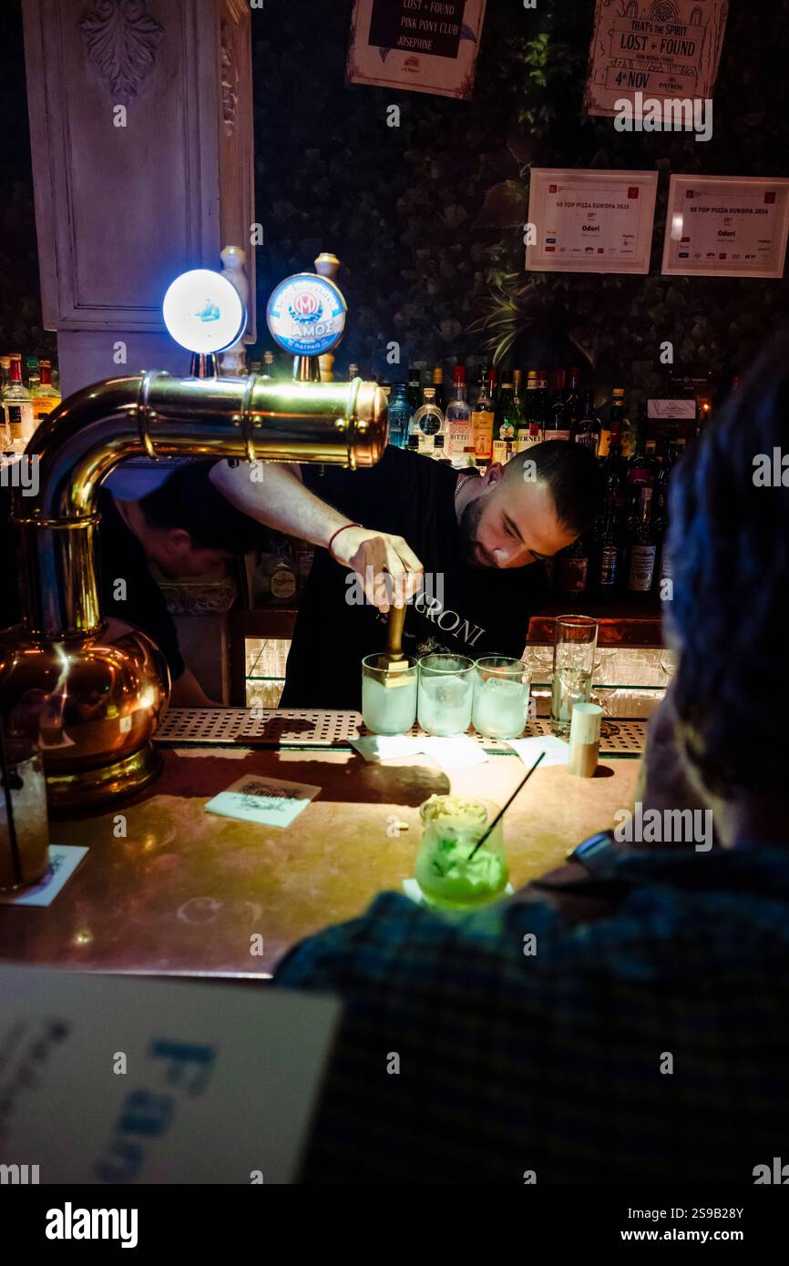 Greek bartender mixing cocktails at the counter of Odori Bar, Athens ...