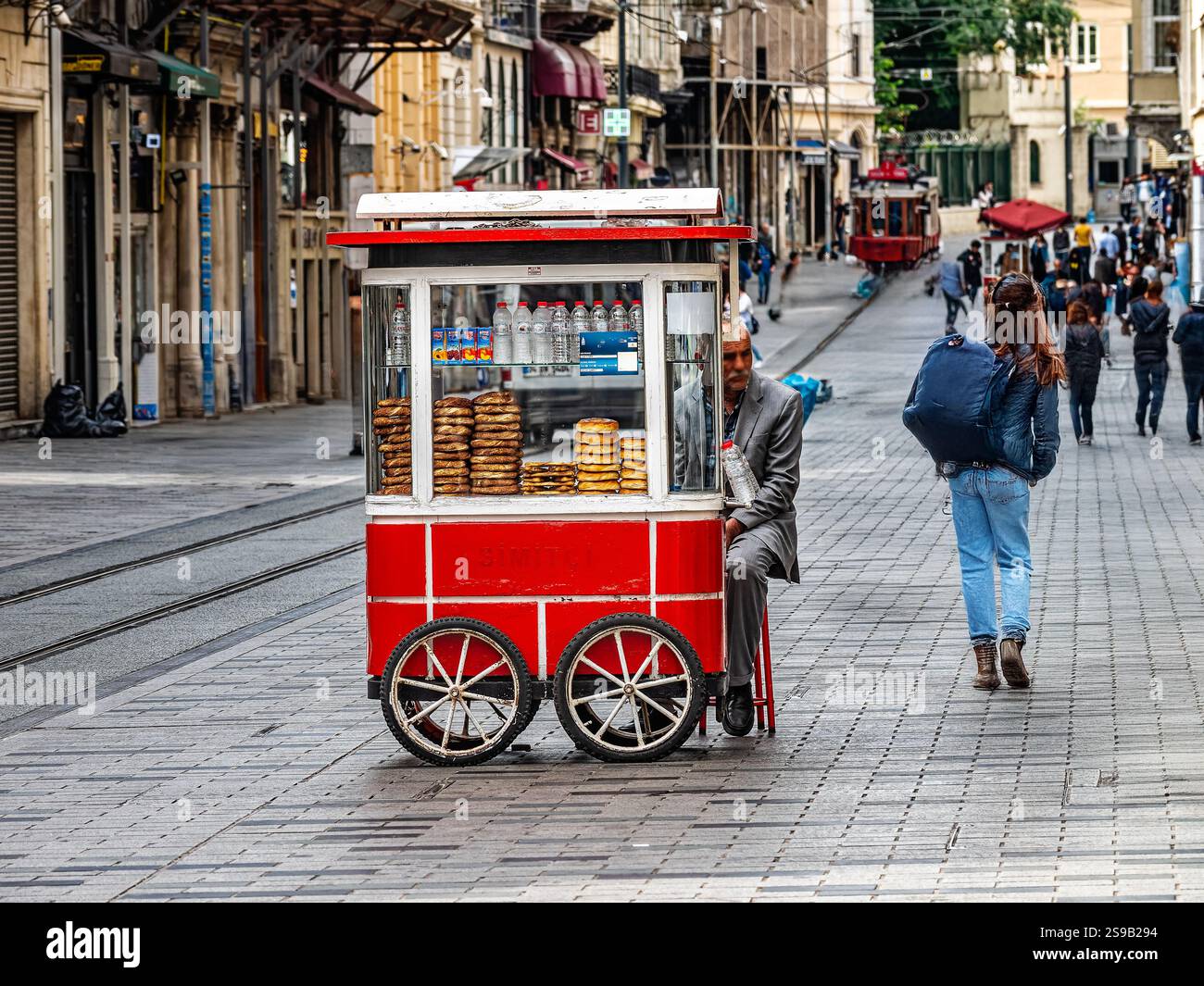 Street vendor cart selling snacks and beverages in a busy urban setting ...
