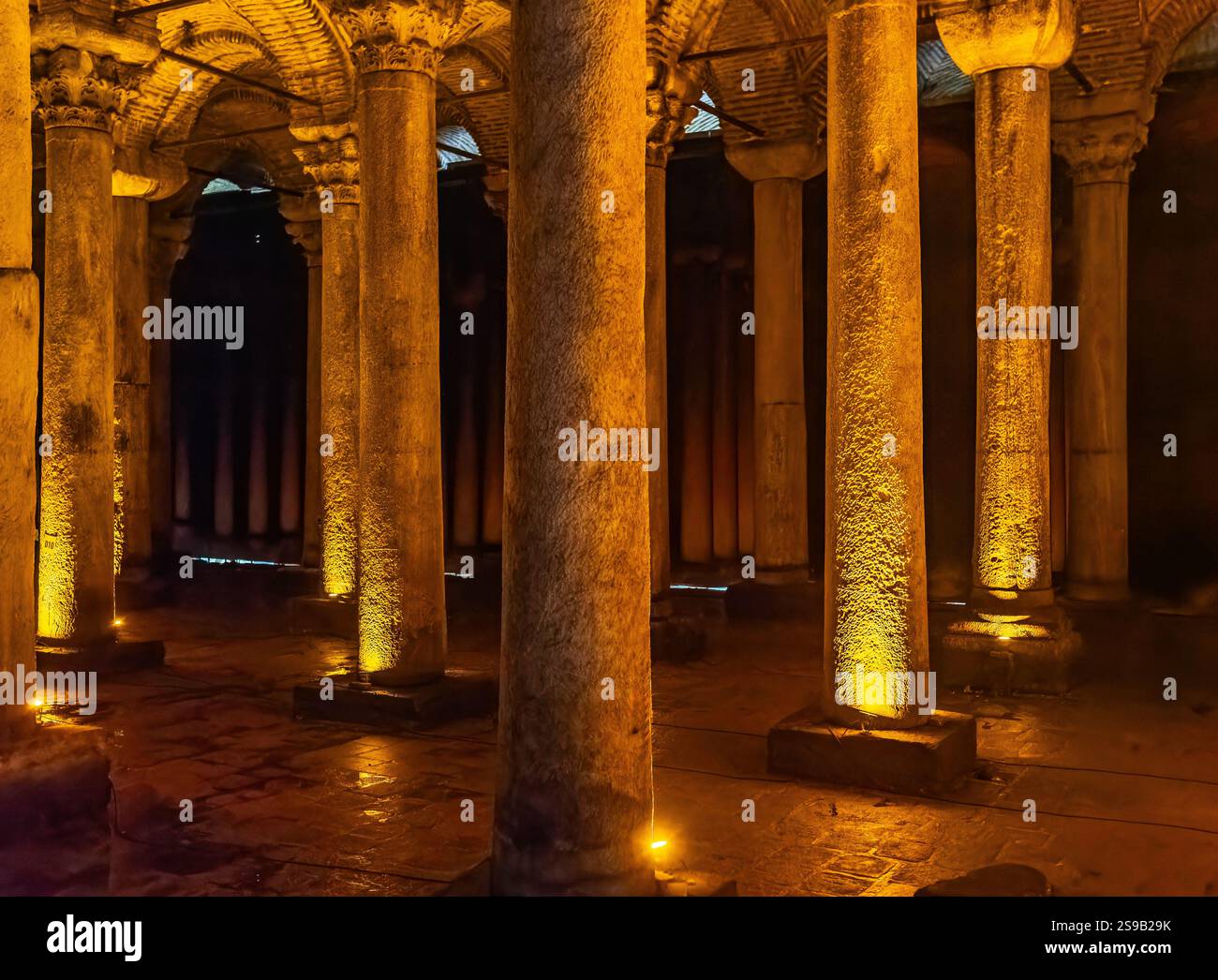 A view of an ancient underground room with columns, dramatically ...