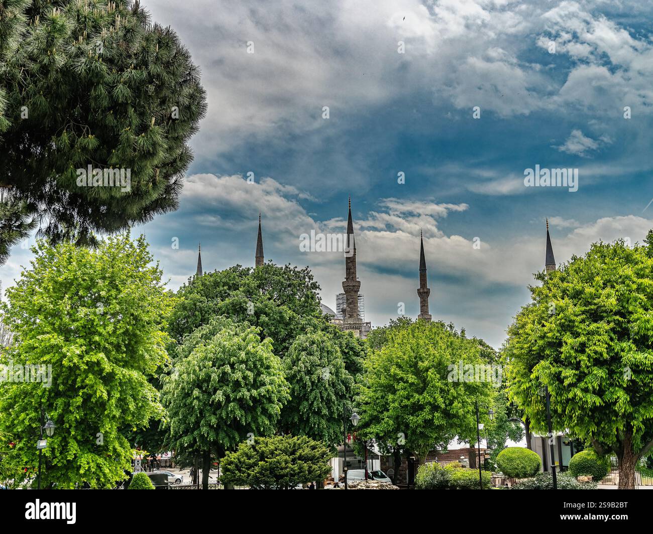 Lush green park vegetation surrounds a historic mosque, featuring ...