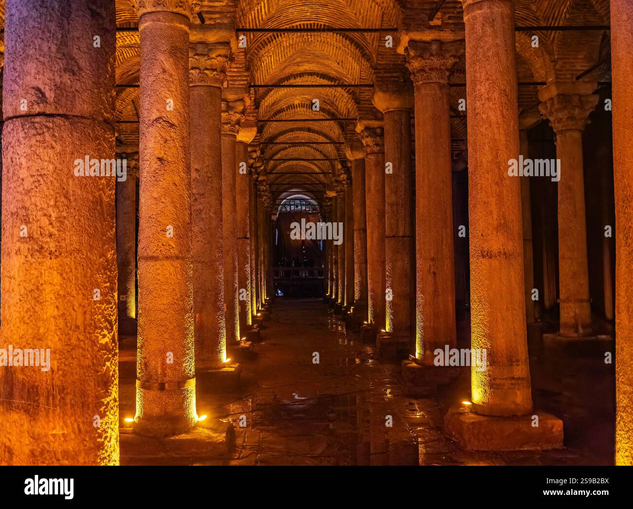 A view of an ancient underground room with columns, dramatically ...