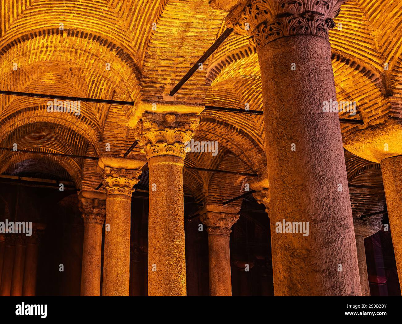 A view of an ancient underground room with columns, dramatically ...