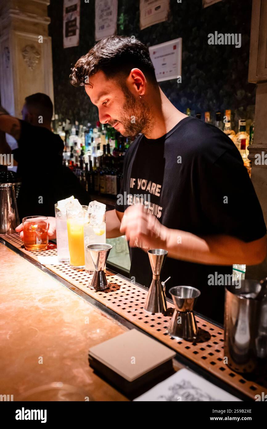 Greek bartender mixing cocktails at the counter of Odori Bar, Athens ...