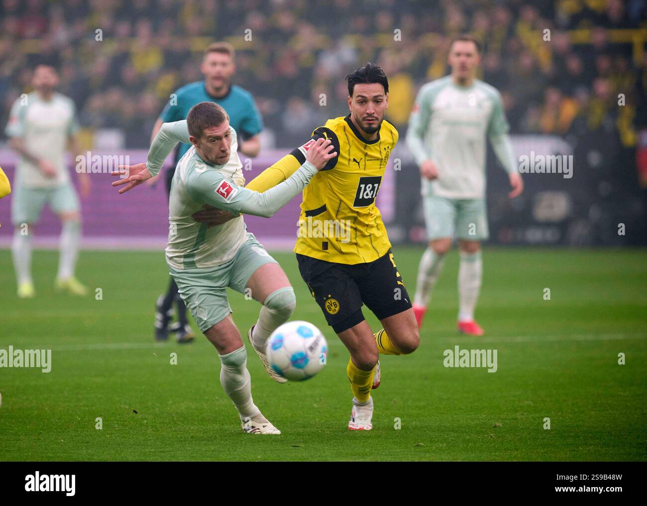 Dortmund's Ramy Bensebaini, left, and Bremen's Mitchell Weiser in ...
