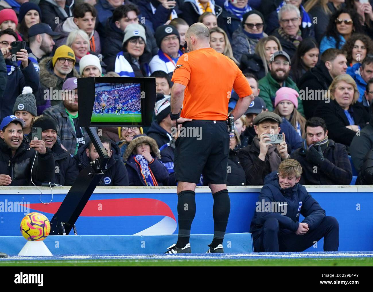 Referee Tim Robinson views the VAR monitor before awarding a penalty to ...