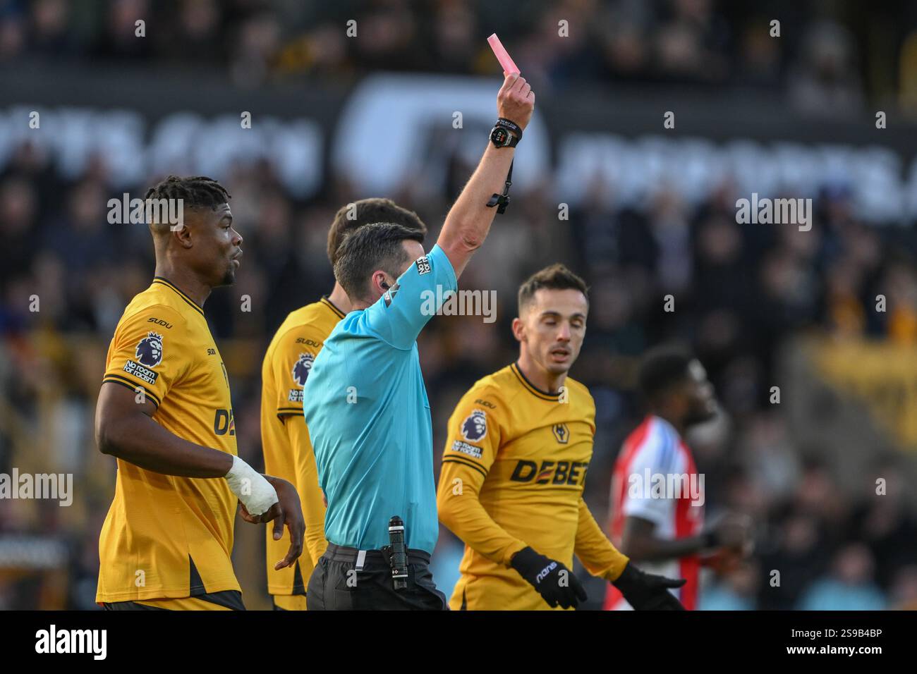 Referee Matt Donohue gives a red card to Myles Lewis-Skelly of Arsenal ...