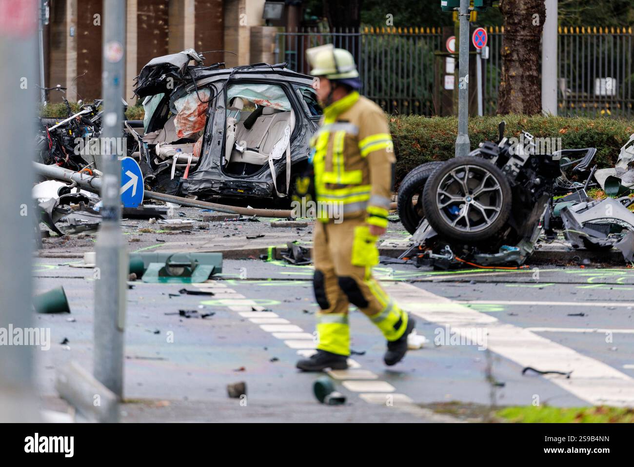 25 January 2025, Duesseldorf: A firefighter walks through the debris ...