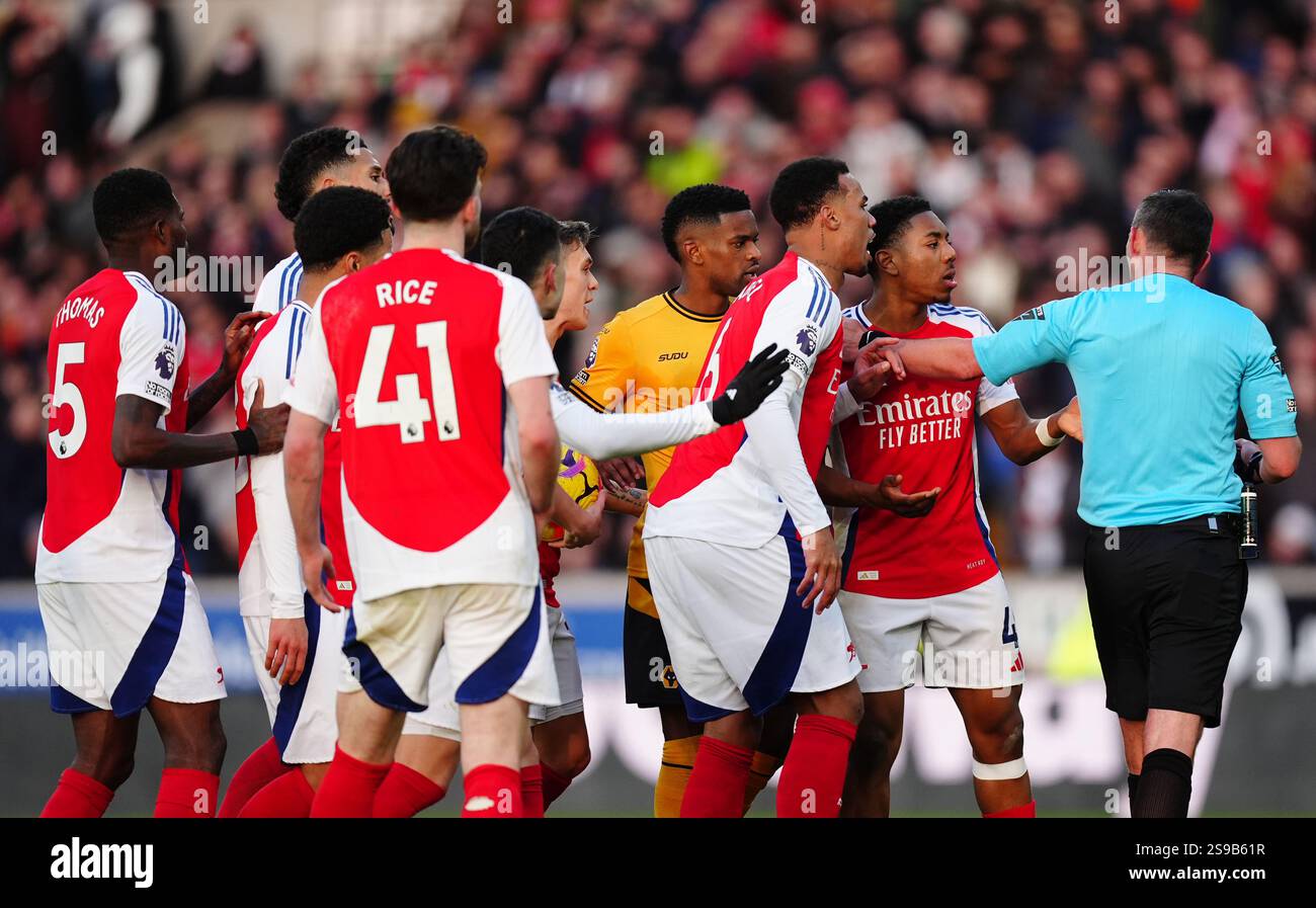 Arsenal players confront referee Michael Oliver after showing Myles ...