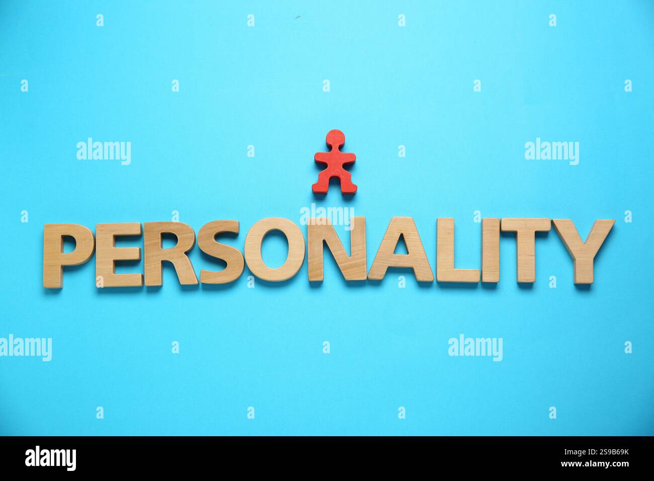 Word Personality made of wooden letters and red human figure on light ...