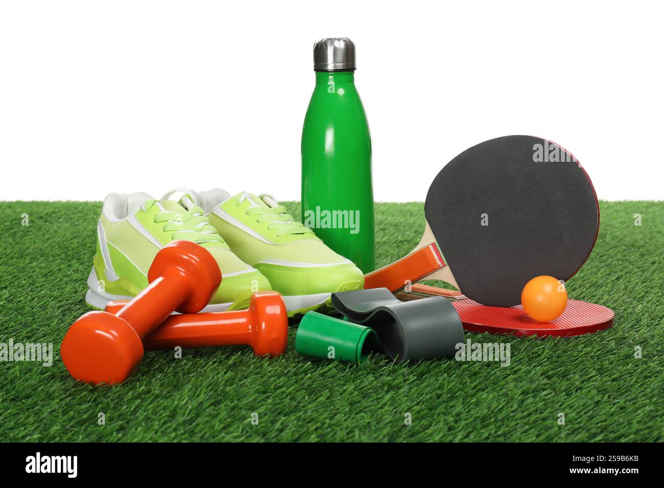 Different sport equipment on green grass against white background Stock ...