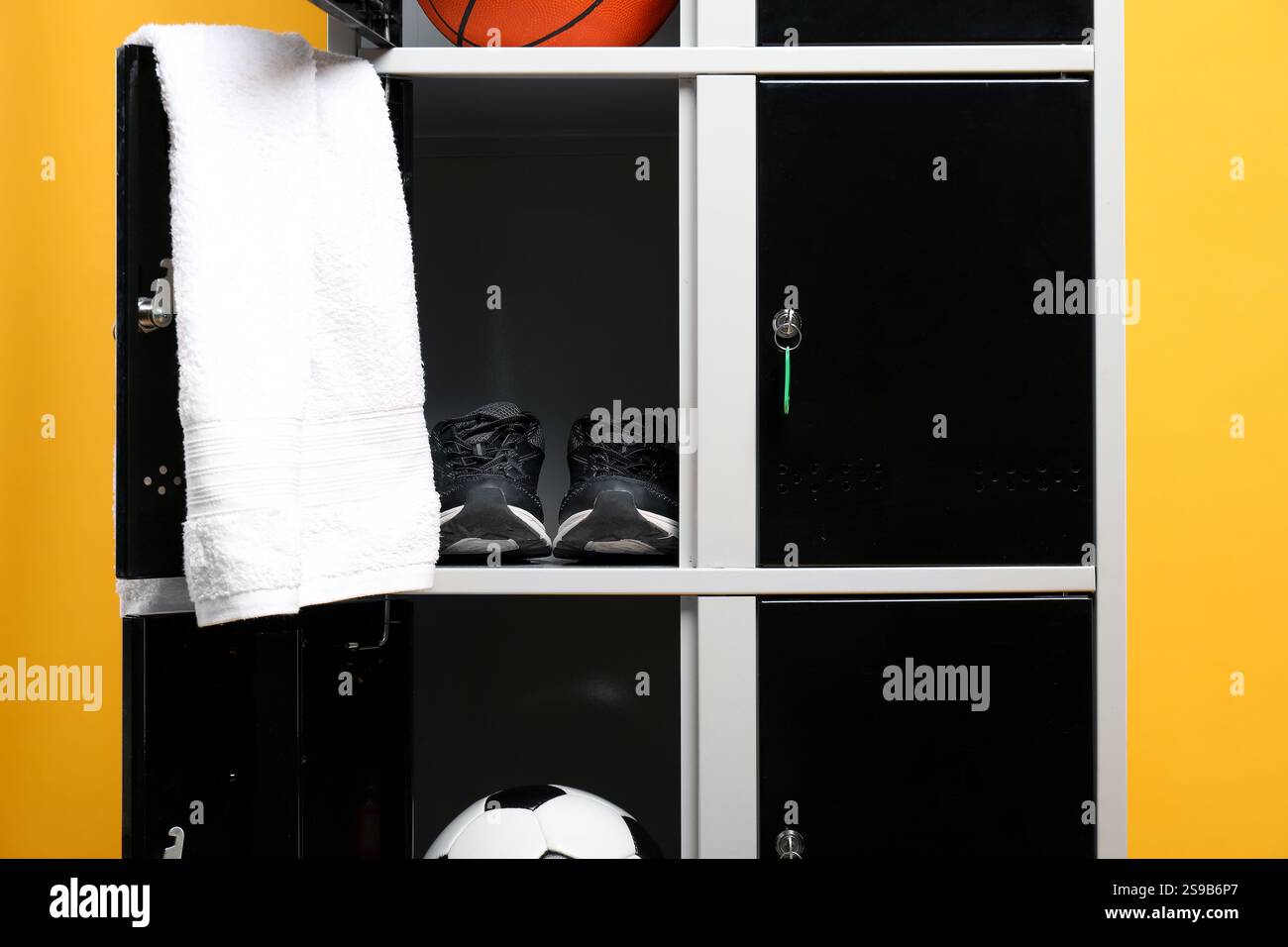Open lockers with sport equipment on orange background Stock Photo - Alamy