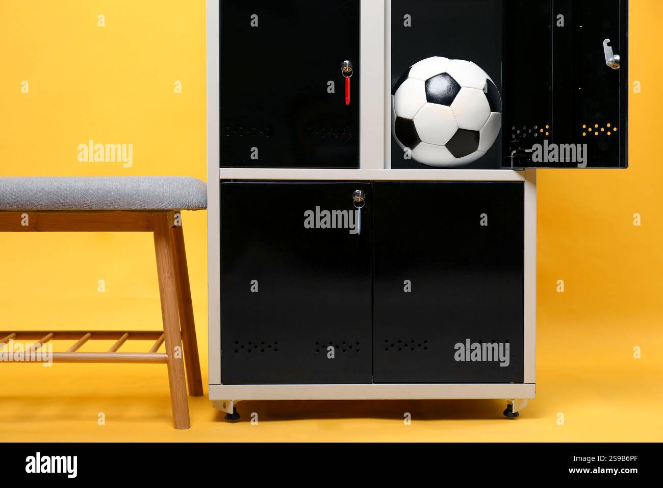 Open locker with soccer ball and bench on orange background Stock Photo ...