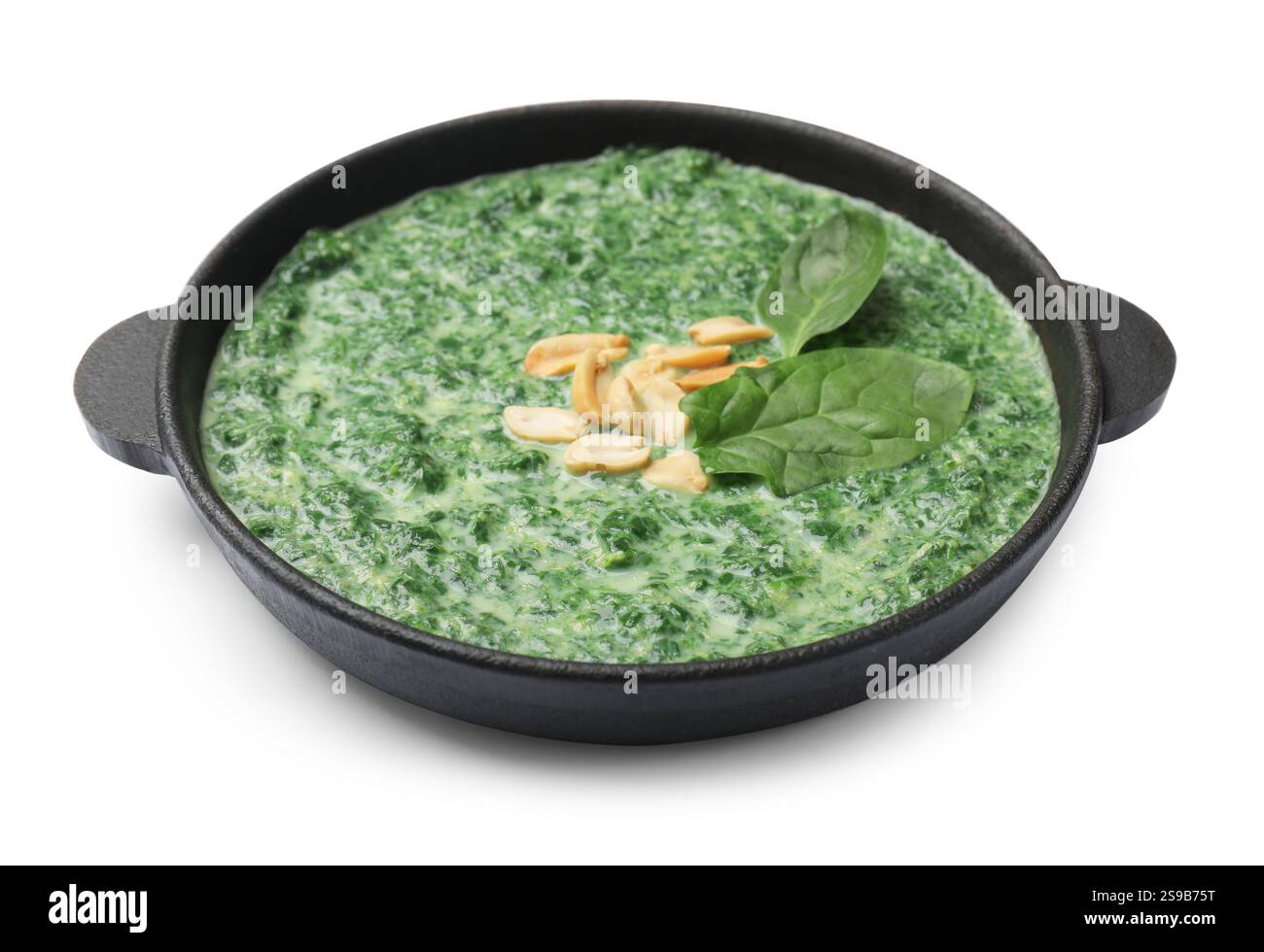 Delicious spinach sauce with peanuts in frying pan isolated on white ...