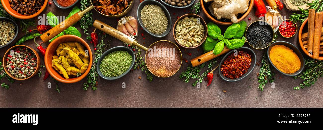 An elegant arrangement of spices and herbs in vivid colors, set against ...