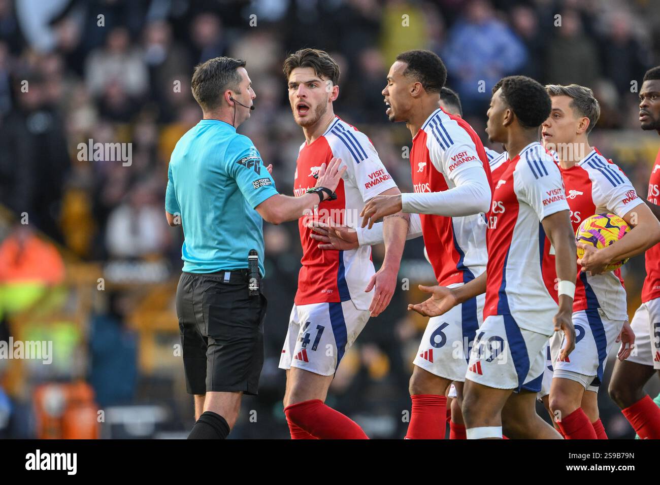 Gabriel of Arsenal argues with referee Michael Oliver over the red card ...