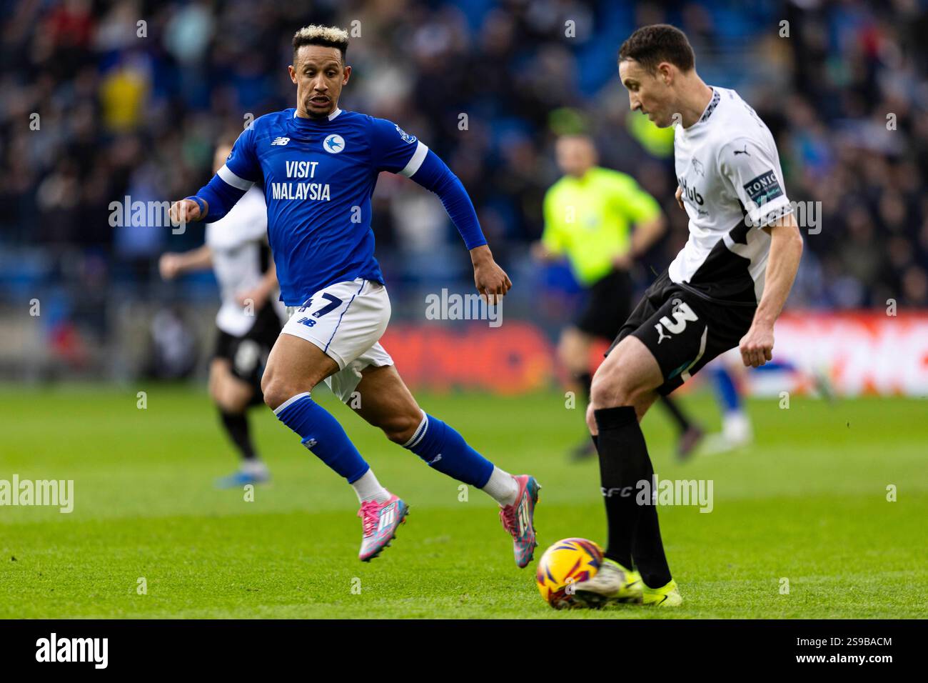 Callum Robinson of Cardiff City (L) closes down Craig Forsyth of Derby ...