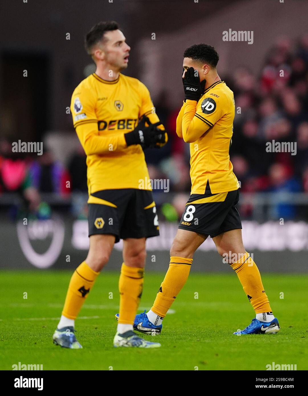 Wolverhampton Wanderers' Joao Gomes (right) reacts after being shown a ...