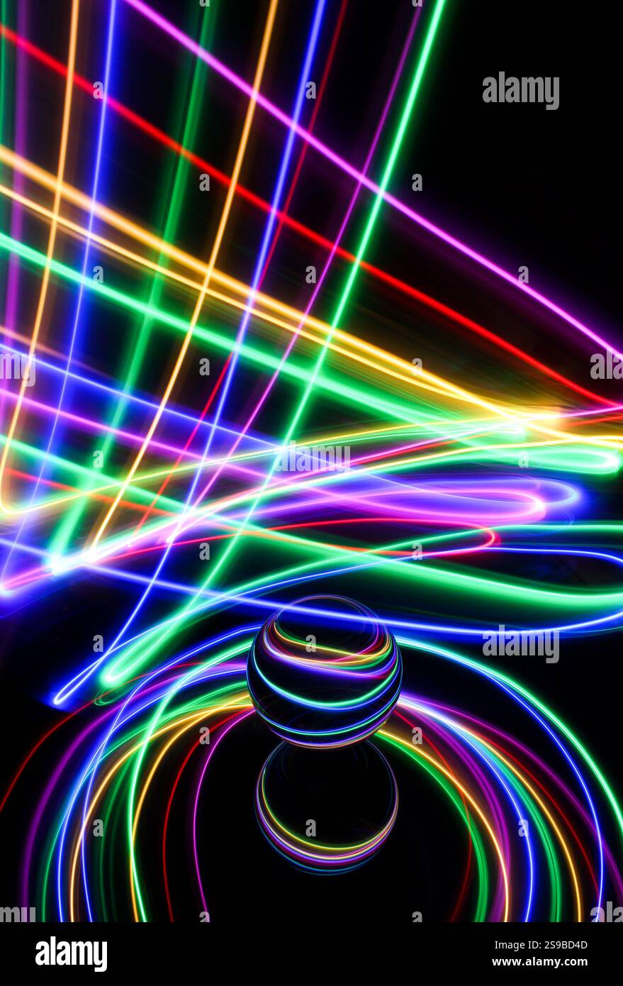 Swirls of colourful light in a long exposure photograph around a glass ...