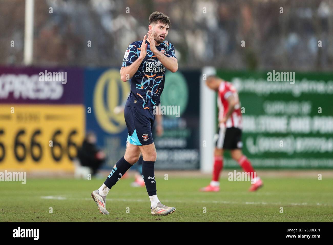 Tom Bloxham of Blackpool applauds the travelling fans as he leaves the ...