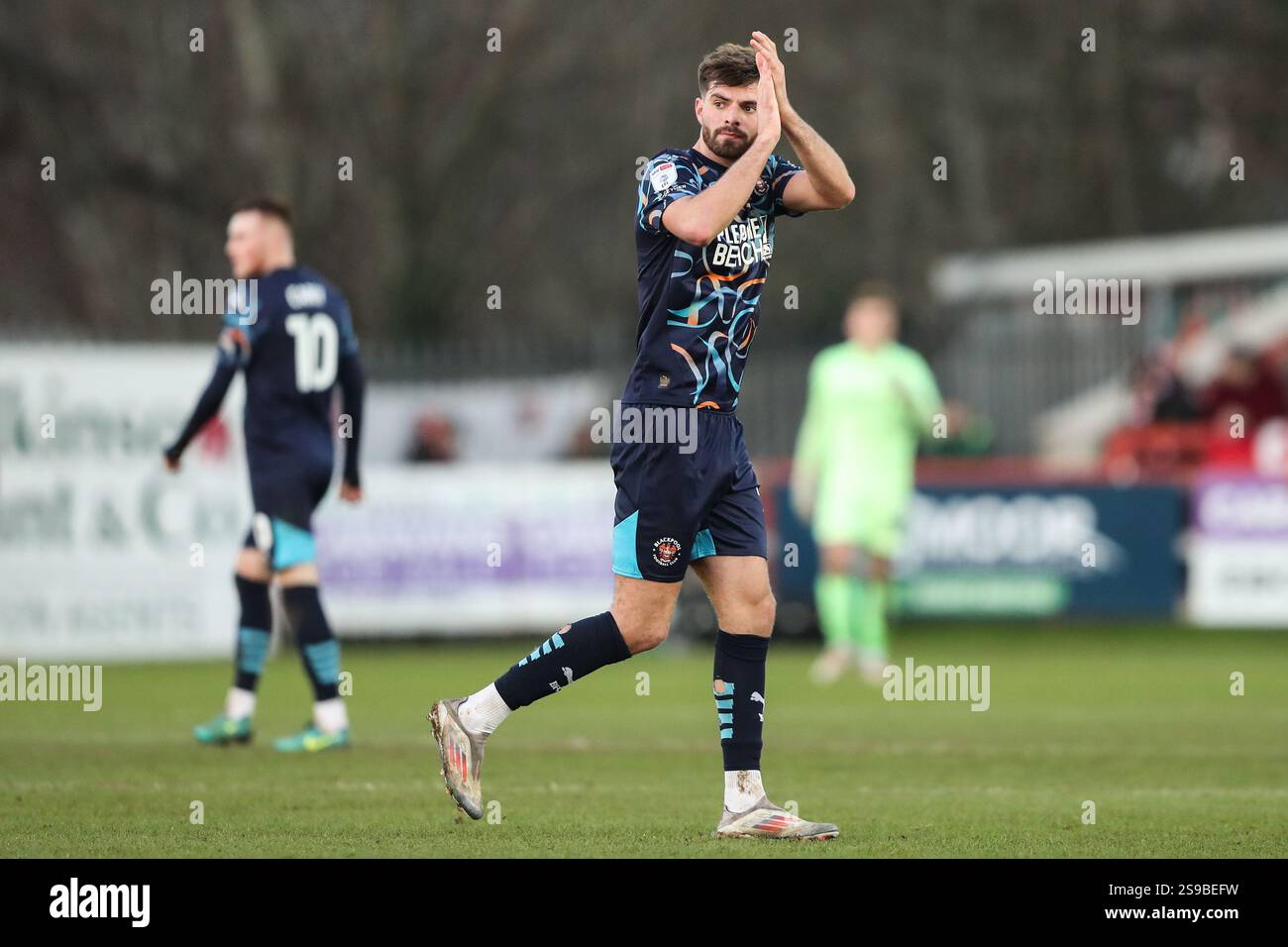 Tom Bloxham of Blackpool applauds the travelling fans as he leaves the ...
